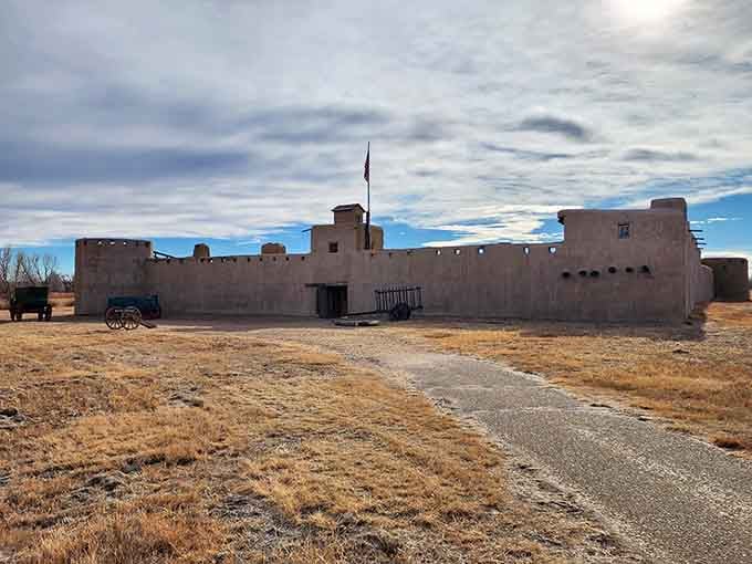 The adobe walls rise from the prairie like something out of an old Western, minus the tumbleweeds and dramatic showdown.