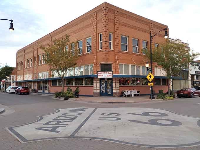 That beautiful brick corner building anchors the famous intersection where countless travelers have stood, guitar in hand or not.