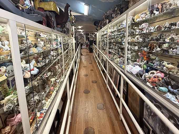 Floor-to-ceiling glass cases packed with thousands of elephants create corridors of pure, concentrated wonder and whimsy.