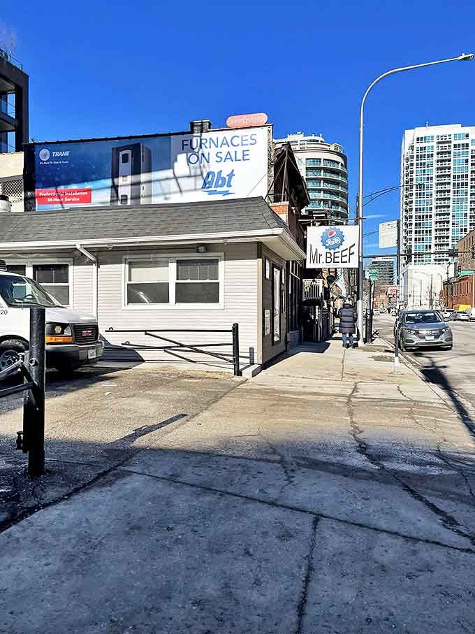 The humble white exterior of Mr. Beef stands as a beacon of hope amid Chicago's gleaming skyscrapers&mdash;proof that culinary treasures often hide in plain sight.