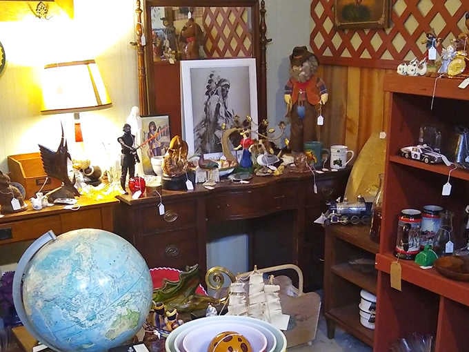 A treasure hunter's dream corner with Western figurines, vintage globe, and collectibles galore&mdash;every shelf tells a different story!
