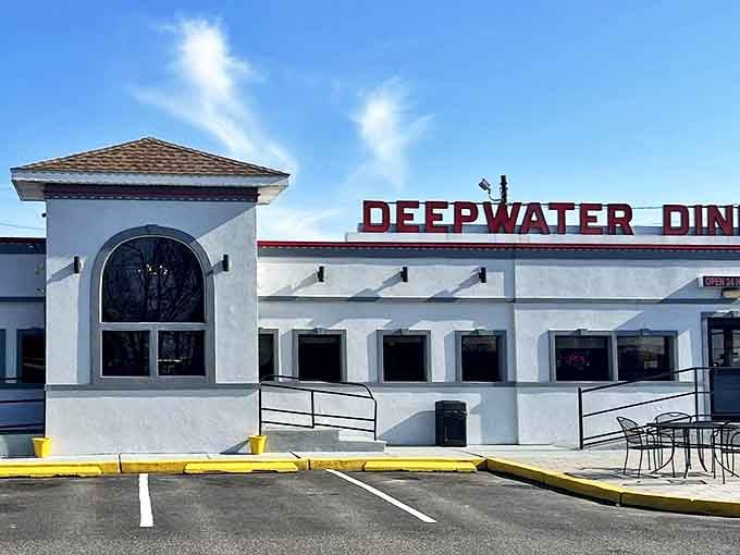 Morning light bathes the diner's crisp white facade, a temple of breakfast where pancake stacks reach heights that would make architects jealous.