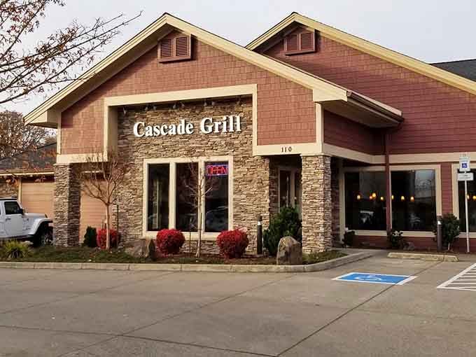 The welcoming facade of Cascade Grill combines rustic stone and burgundy siding, inviting meat lovers to discover Albany's prime rib paradise.