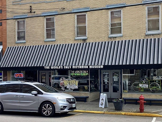 The unassuming storefront of the world's only Mothman Museum beckons curious travelers with its distinctive black and white striped awning &ndash; cryptid hunting never looked so inviting!