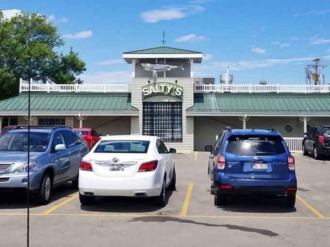 Salty's exterior stands proudly against Wisconsin's blue sky, its nautical charm and shark mascot promising seafood adventures in the most unexpected of places.