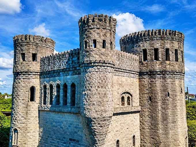Medieval majesty meets Florida sunshine as Castle Otttis's imposing towers rise above the coastal greenery, looking like it was airlifted straight from the Irish countryside.