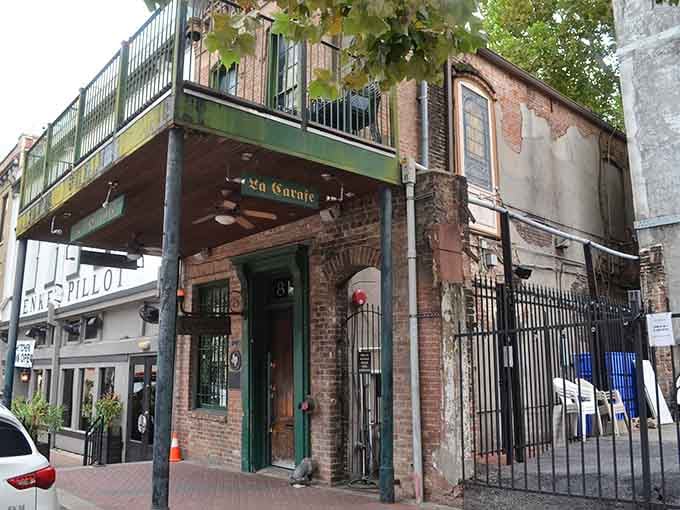 That weathered brick and green balcony have witnessed more Houston history than any textbook could capture.
