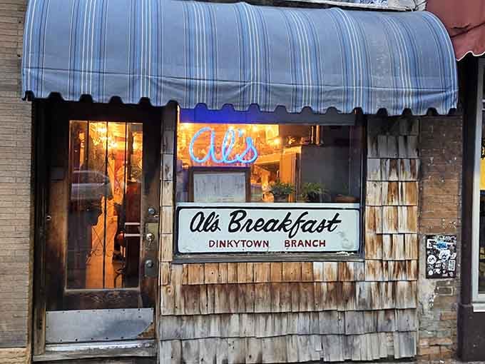 That blue-and-white striped awning has welcomed breakfast lovers through this narrow doorway for generations of Minneapolis mornings.