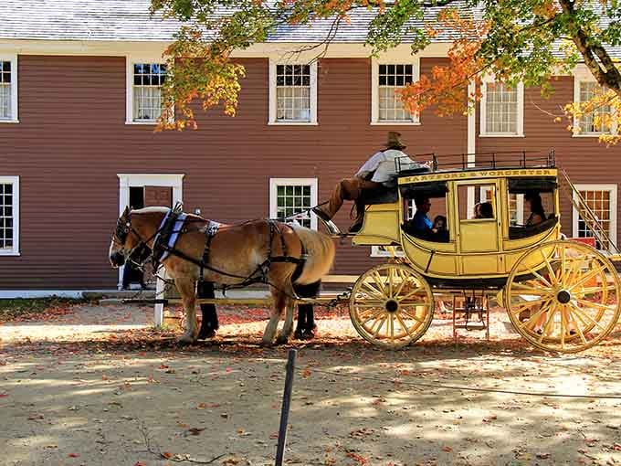 That bright yellow stagecoach isn't heading to a Western movie set, it's your ride through 1830s New England history.