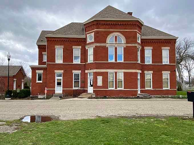 The red brick facade stands proud against moody skies, like it's daring you to come explore its secrets.