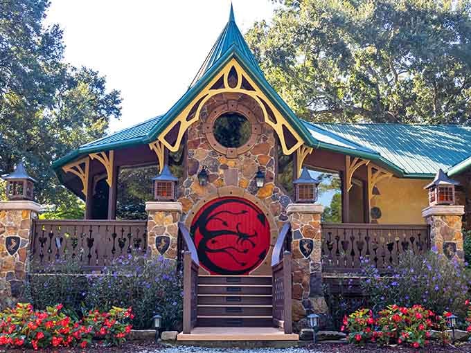 The striking red circular door and intricate stonework showcase the castle's commitment to fairy tale details that captivate every visitor.