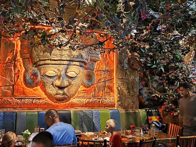 Ancient temple faces glow orange during the storm sequence, proving that dinner theater doesn't need actual actors to be spectacular.