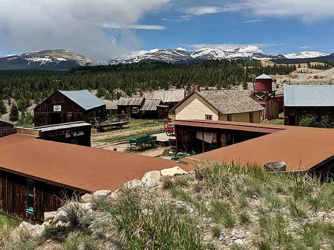 Snow-capped peaks tower over weathered buildings where miners once dreamed of striking it rich in Colorado's high country.