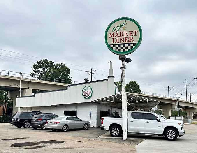 That classic diner sign rising above the parking lot is your beacon to breakfast bliss and retro perfection.