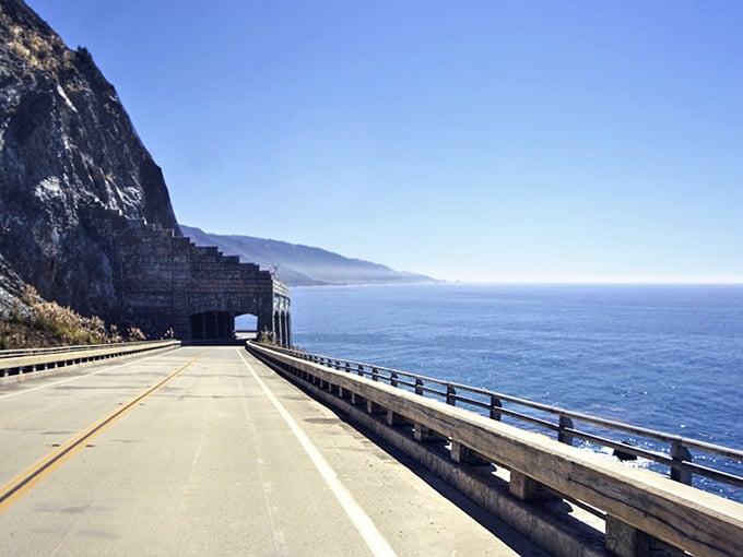 Highway 1 stretches before you like nature's red carpet, where the mountain's rugged edge meets the Pacific's endless blue canvas.