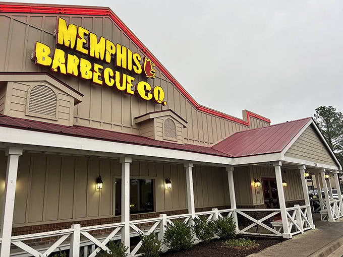 Dusk settles over this temple of smoke, where championship barbecue dreams come true. The warm glow of porch lights welcomes you like an old friend's embrace.