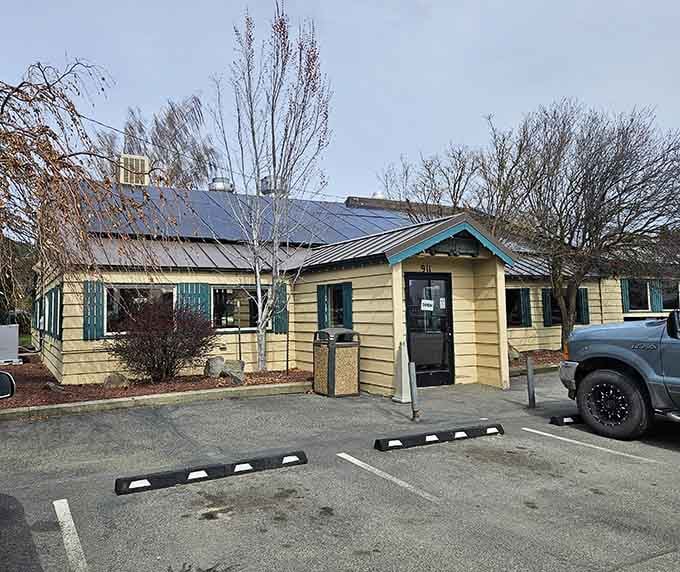 The unassuming yellow exterior of Cottage Cafe hides culinary treasures within, like a delicious novel you can't judge by its cover.