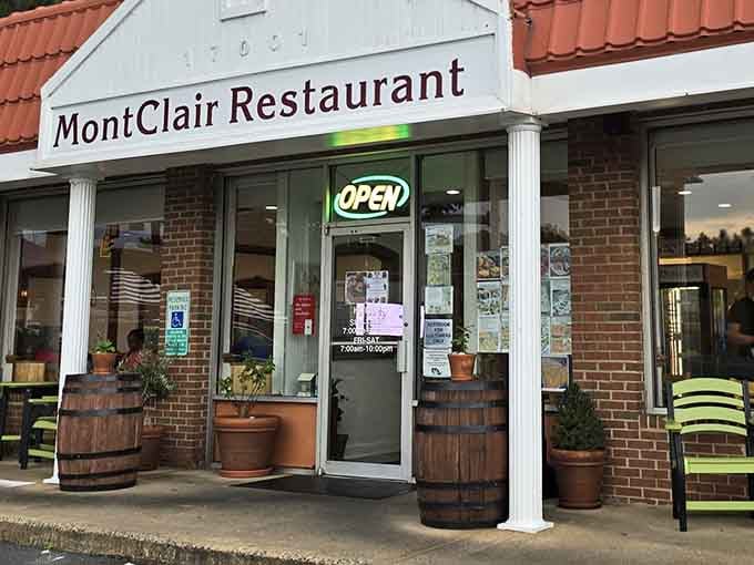 The unassuming exterior of Montclair Family Restaurant, where those wooden barrels aren't just for show&mdash;they're guarding the entrance to gyro paradise.