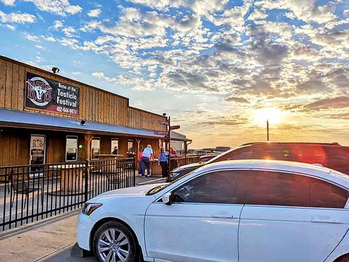 Nebraska sunset paints the sky above Round the Bend Steakhouse, where diners gather for evening meals worth the drive.