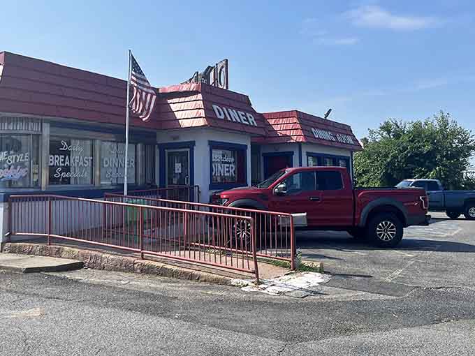 The American flag waves proudly above this breakfast sanctuary, promising comfort food and patriotic portions inside.