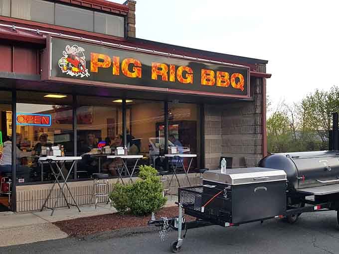 The glowing Pig Rig BBQ sign beckons like a smoky lighthouse for the hungry and barbecue-deprived souls of Connecticut.