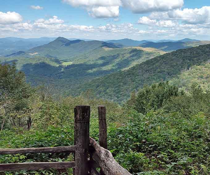 Mountains stacked like nature's layer cake, each ridge a different shade of green and blue perfection.