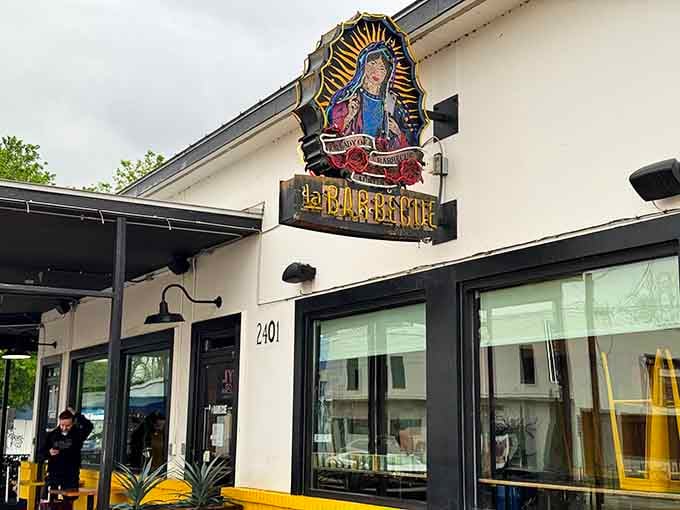 That colorful sign featuring Our Lady of Guadalupe isn't just decoration, it's a beacon calling barbecue pilgrims home to smoky salvation.