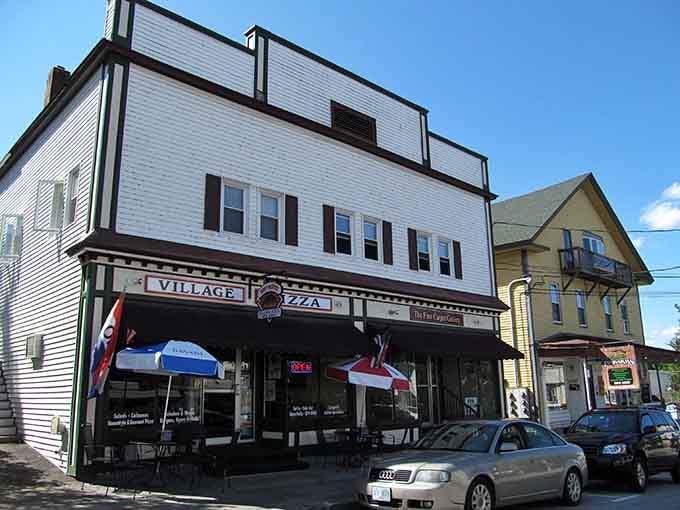 Village Pizza stands as a testament to small-town charm, where locals gather for slices and stories beneath classic New England clapboard.