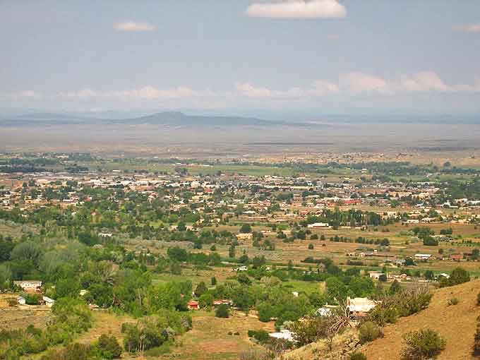Taos spreads across the high desert valley like a patchwork quilt, nestled beneath New Mexico's endless blue sky.