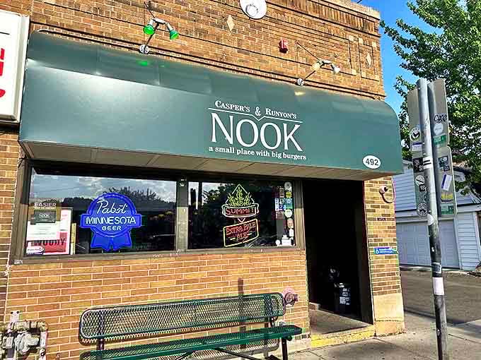 The Nook's classic green awning stands as a beacon of burger hope on Hamline Avenue, where that simple bench has supported the weight of countless hungry Minnesotans contemplating their imminent cheese-stuffed bliss.