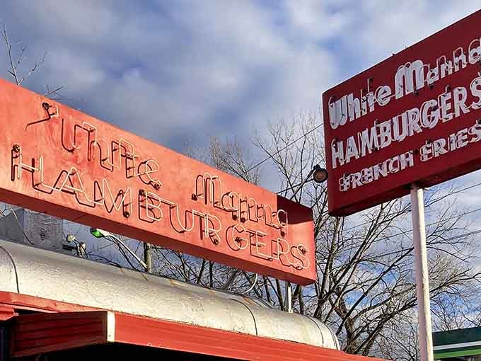 The iconic red and white signage of White Manna stands out against the sky like a beacon calling all burger enthusiasts home.
