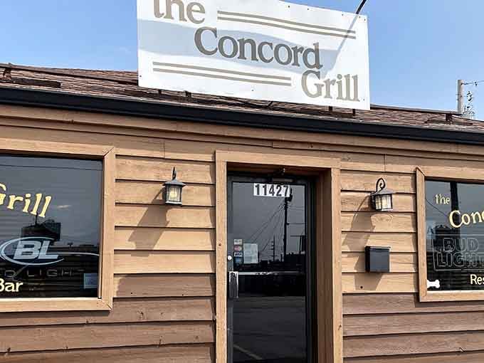 The unassuming wooden exterior of The Concord Grill proves once again that culinary treasures often hide behind the most modest facades.