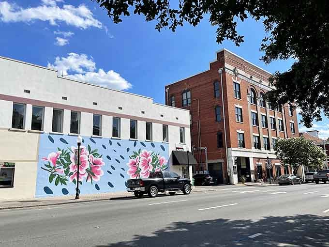 Downtown Valdosta's floral mural bursts with pink azaleas against a blue backdrop, bringing the city's nickname to life on this historic building's facade.