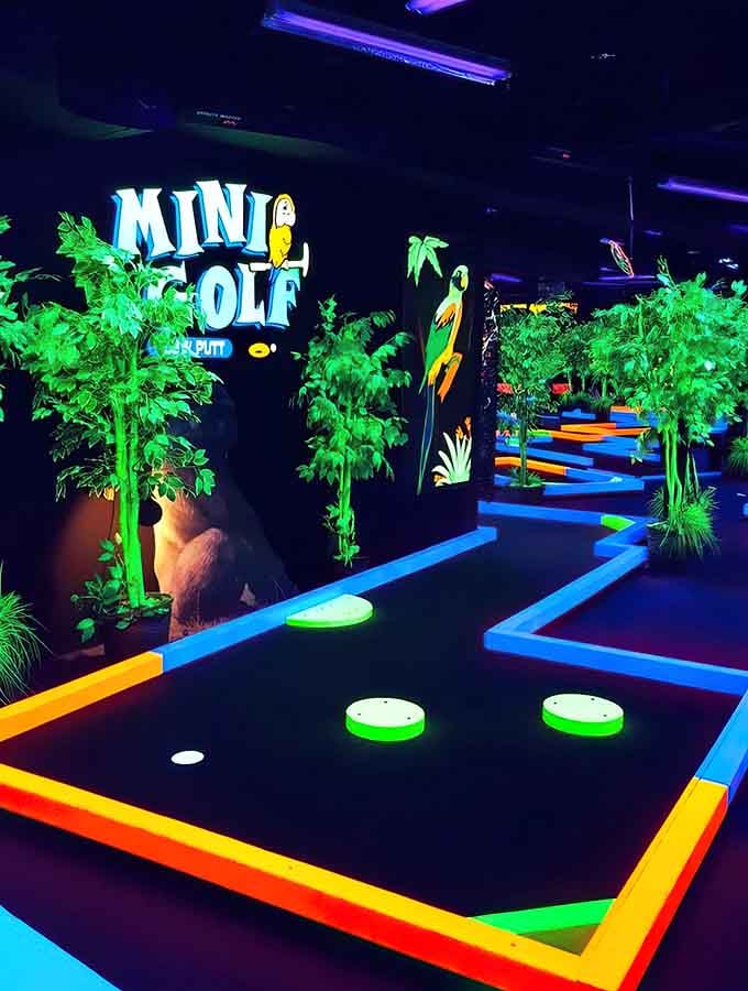 Multiple lanes of neon-bright mini golf stretch before you like a fluorescent highway to fun and friendly competition.