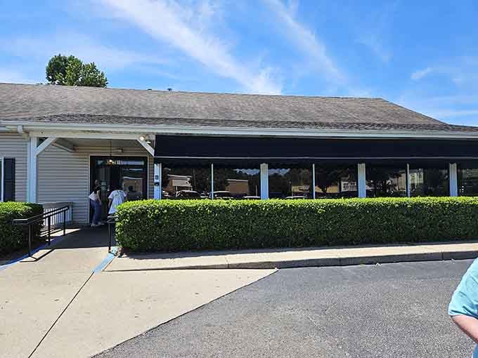 Bathed in Alabama sunshine, Paw Paw Patch's exterior might not scream "culinary destination," but locals know better. The neatly trimmed hedges are like the gatekeepers to meat-and-three heaven.