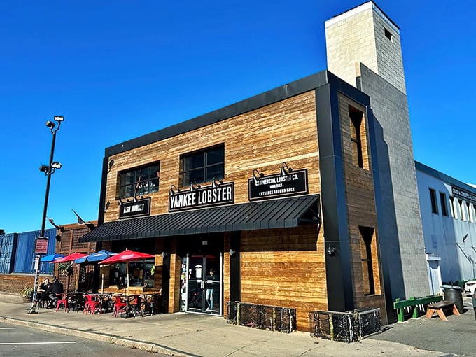 Blue umbrellas dot the sidewalk like buoys, inviting seafood lovers to drop anchor at this unassuming harbor gem.