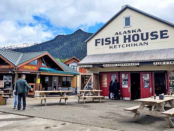 The quintessential Alaskan seafood experience stands proudly against a backdrop of mountains, where picnic tables and happy diners signal you've found the real deal.