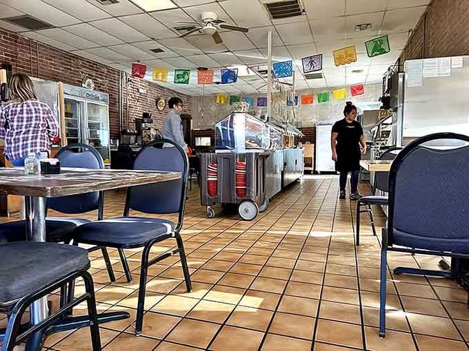 Colorful papel picado banners dance overhead while staff prepare for the day's fiesta of flavors &ndash; this isn't just a meal, it's a celebration.