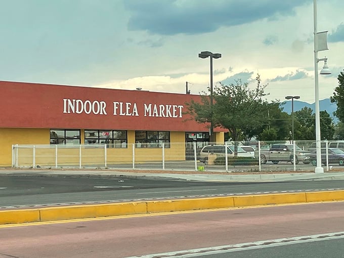 The welcoming terracotta facade of the Indoor Flea Market stands ready for shoppers under New Mexico's dramatic sky.