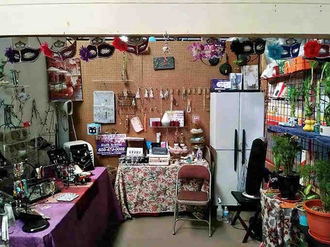 A treasure hunter's paradise! This vendor booth showcases everything from decorative masks to potted plants, with pegboard walls displaying a lifetime of collectibles.