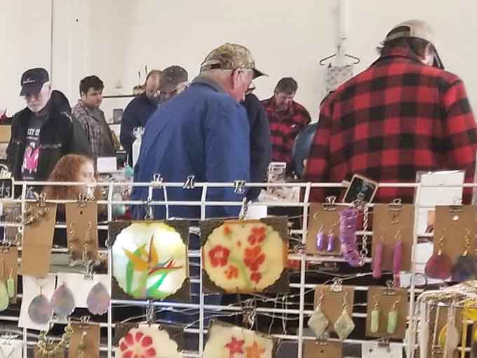 Colorful glass art catches the light while shoppers hunt for hidden gems among the carefully arranged vendor displays.