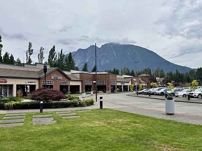 That manicured lawn meets mountain majesty in a way that makes regular shopping centers look downright apologetic.