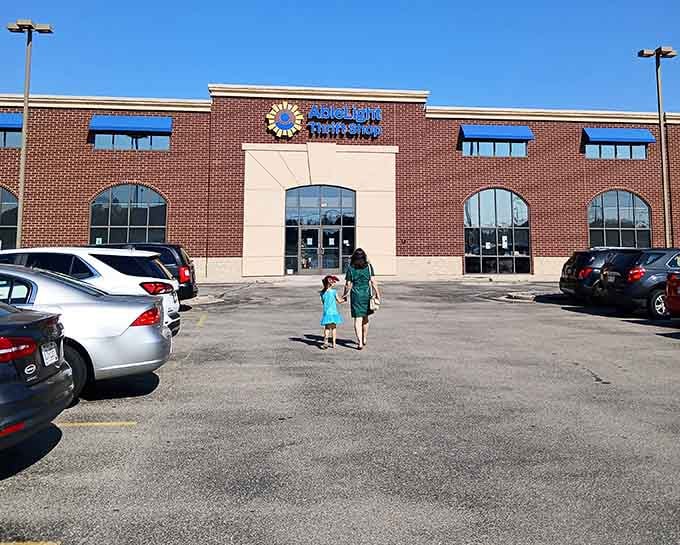 Sunshine bathes the brick facade as shoppers make their pilgrimage to this temple of thrift, where yesterday's castoffs become tomorrow's treasures.