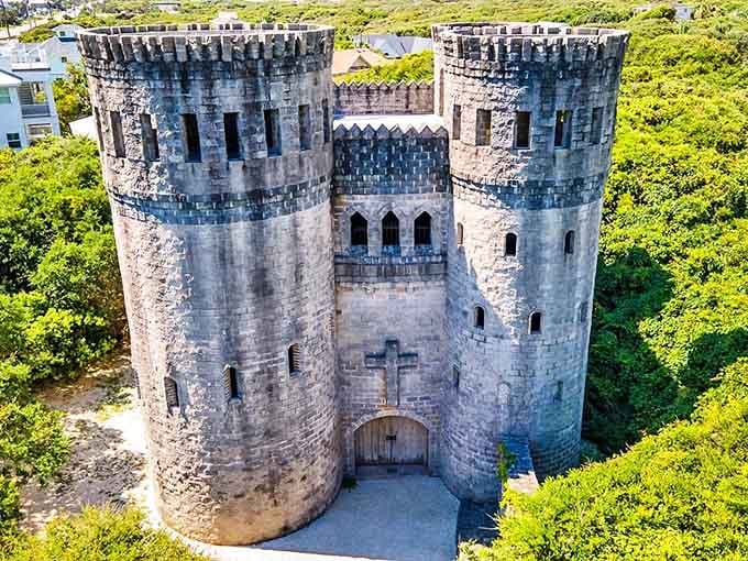 Medieval majesty meets Florida sunshine as Castle Otttis's imposing towers rise above the coastal greenery, looking like it was airlifted straight from the Irish countryside.