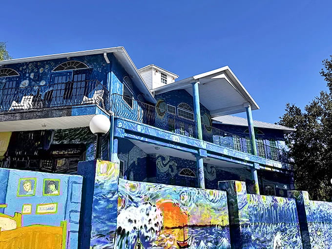 Sunlight illuminates the vibrant blues and yellows of the Van Gogh House, creating a striking contrast against Florida's clear sky.