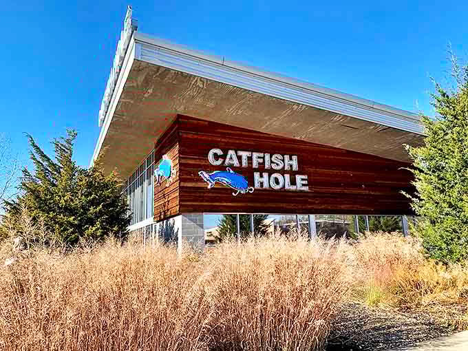 The distinctive blue catfish logo adorns the restaurant's wooden facade, a beacon for seafood lovers in landlocked Arkansas.