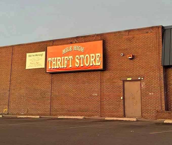 That orange sign against brick isn't just announcing a store – it's beckoning you toward retail therapy paradise.
