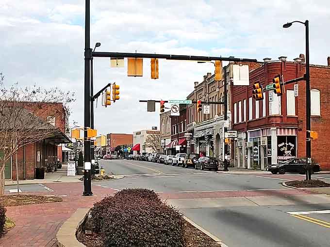 Main Street Mooresville looks like it was plucked straight from a movie set, where modern traffic lights stand guard over two centuries of perfectly preserved American history.