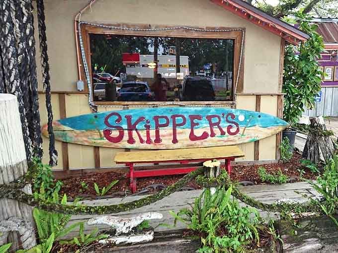 The weathered surfboard sign says it all: you've arrived somewhere authentically Florida, where time slows down and appetites come alive.