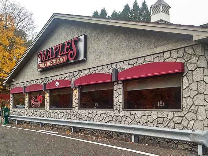 The stone facade of Maples Family Restaurant stands as Middlebury's beacon of breakfast bliss, its iconic red sign promising comfort food paradise within.